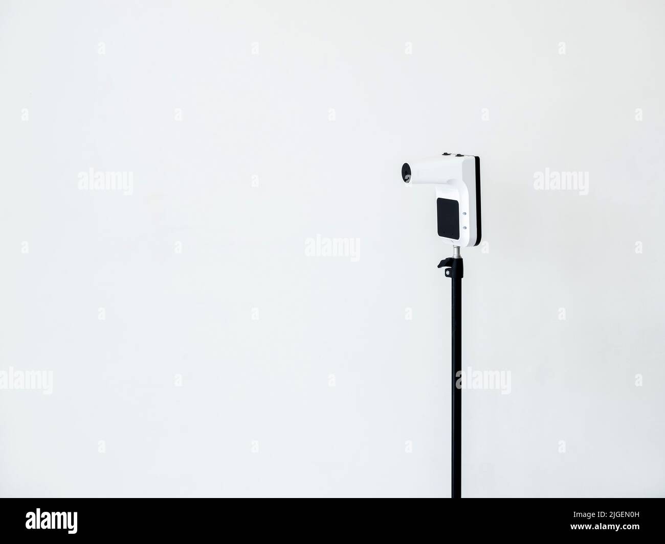 White infrared thermometer, digital thermometer with stand isolated on ...