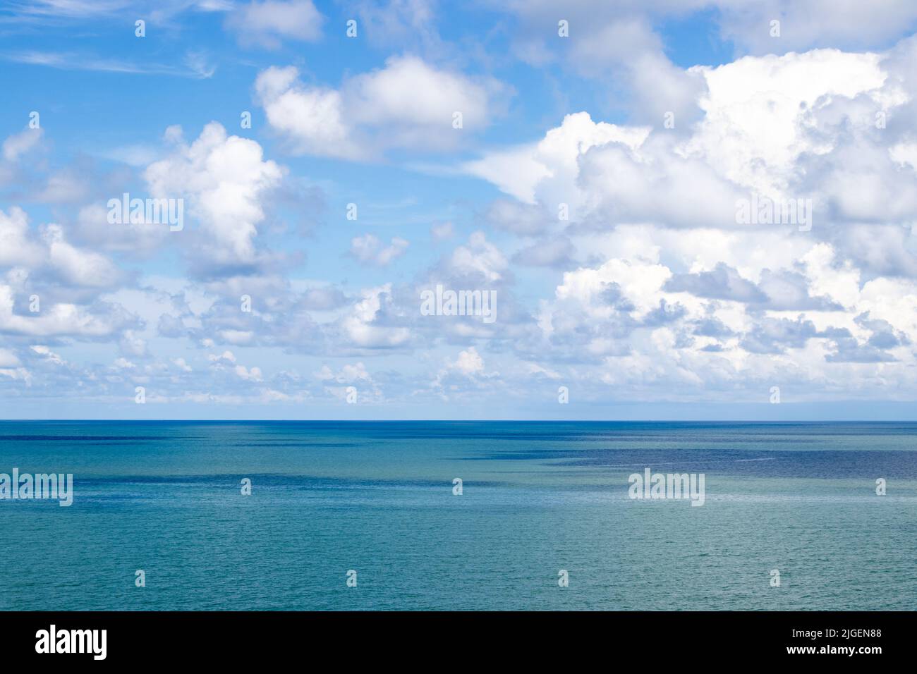 Beautiful calm turquoise color sea and blue sky with white color cloud ...