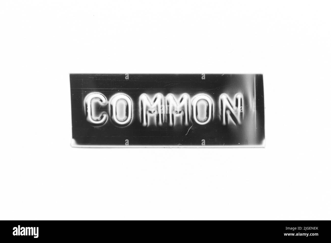 Black color banner that have embossed letter with word common on white ...