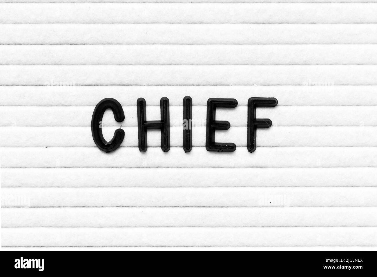 Black color letter in word chief on white felt board background Stock ...