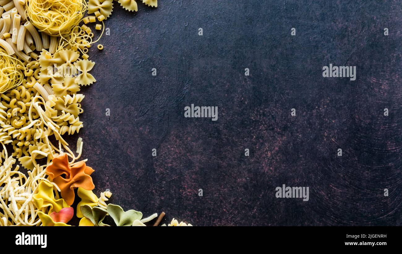 Dry pasta shapes forming a left side border with copy space to the ...