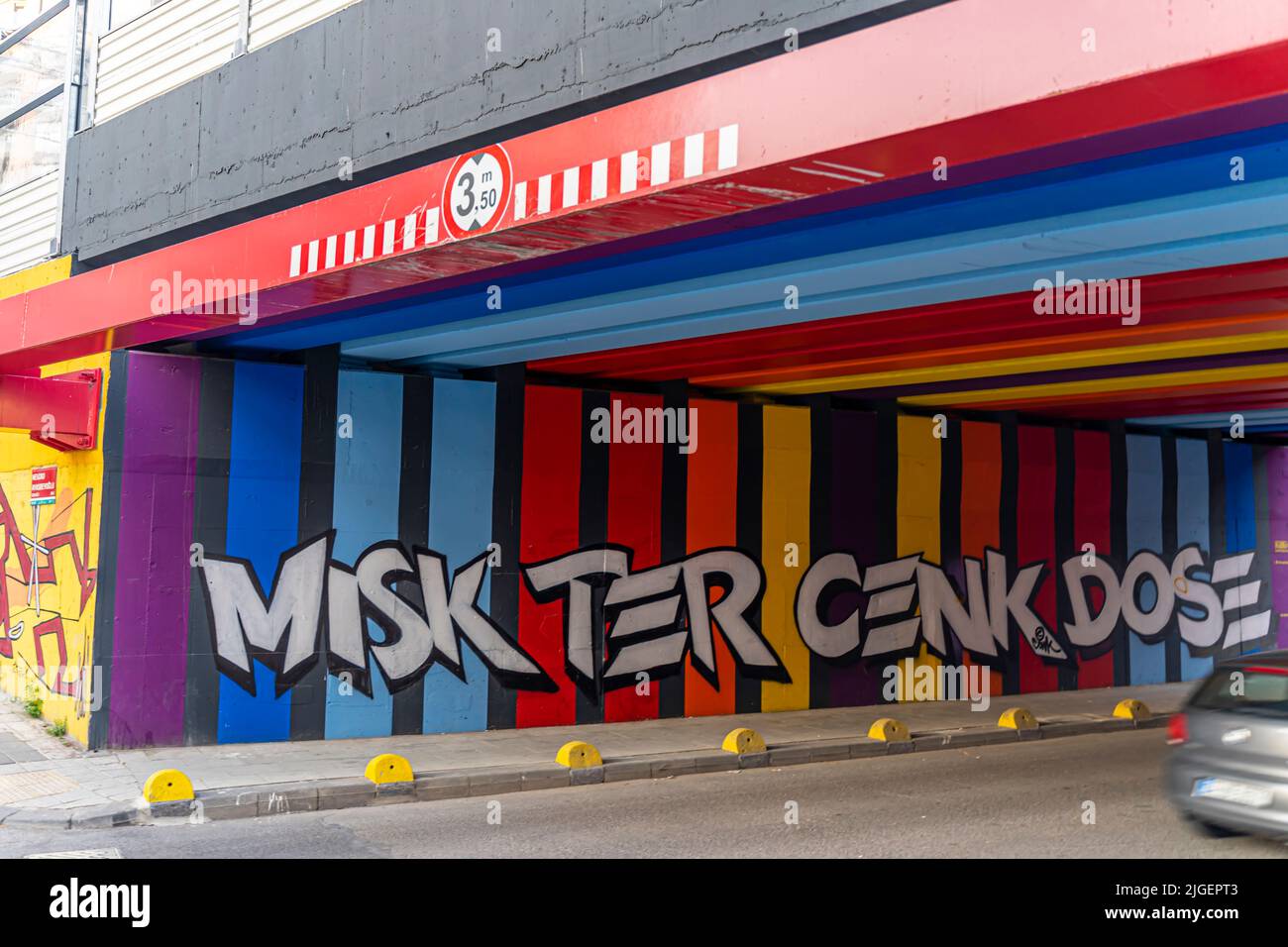 Mural in tunnel with MISK TER CENK DOSE writing. rainbow colors in ...