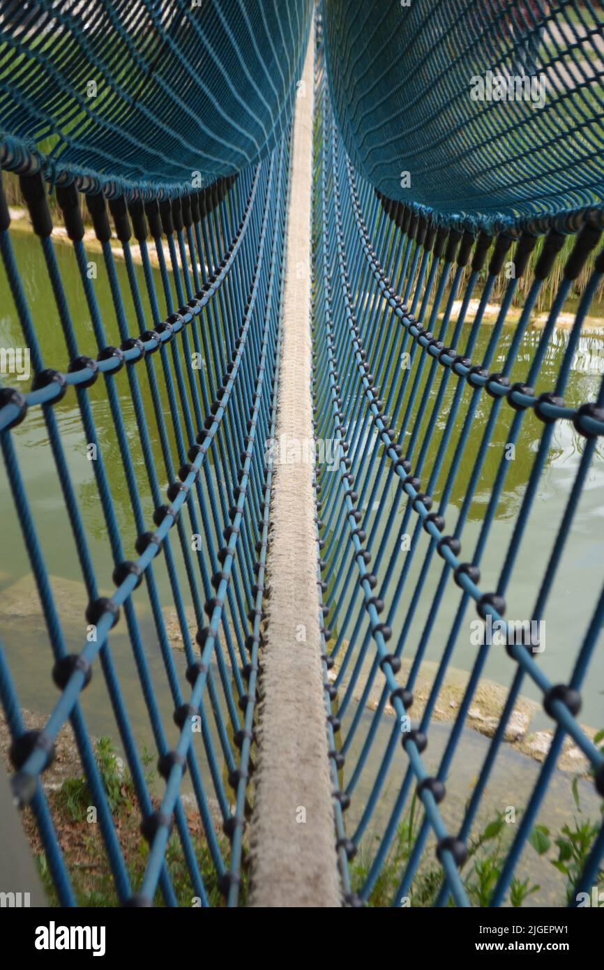 climb net rope adventure park playground over lake Stock Photo - Alamy