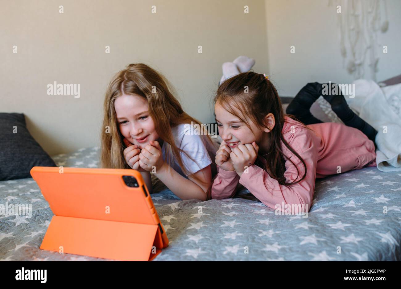 Two girls friends watch cartoons at home after school, have fun Stock ...