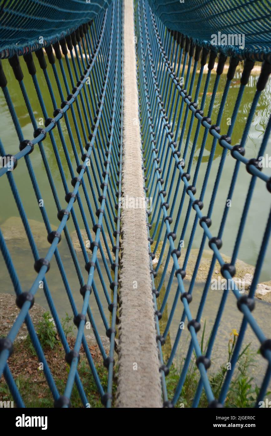 climb net rope adventure park playground over lake Stock Photo - Alamy