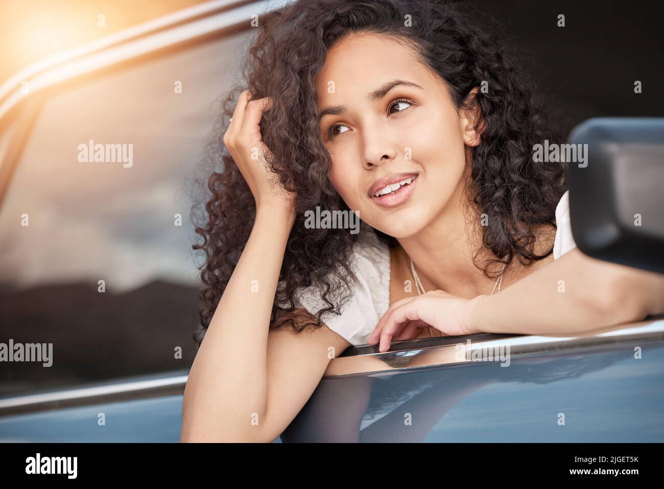 This road trip was a good idea. a beautiful young woman leaning out the ...