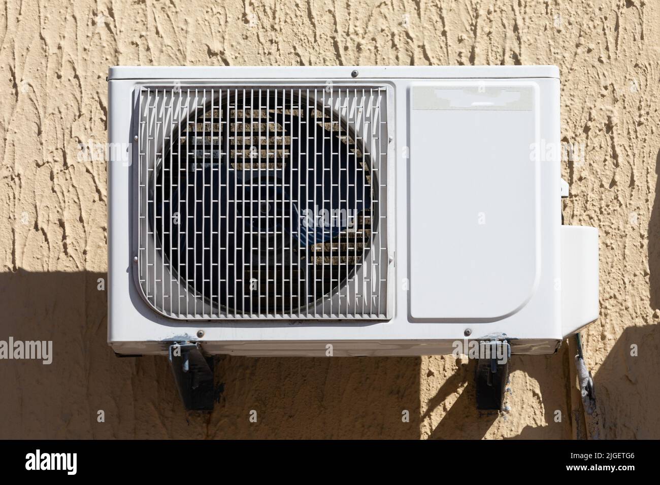 outdoor unit of a domestic air conditioner with a fan outside the ...