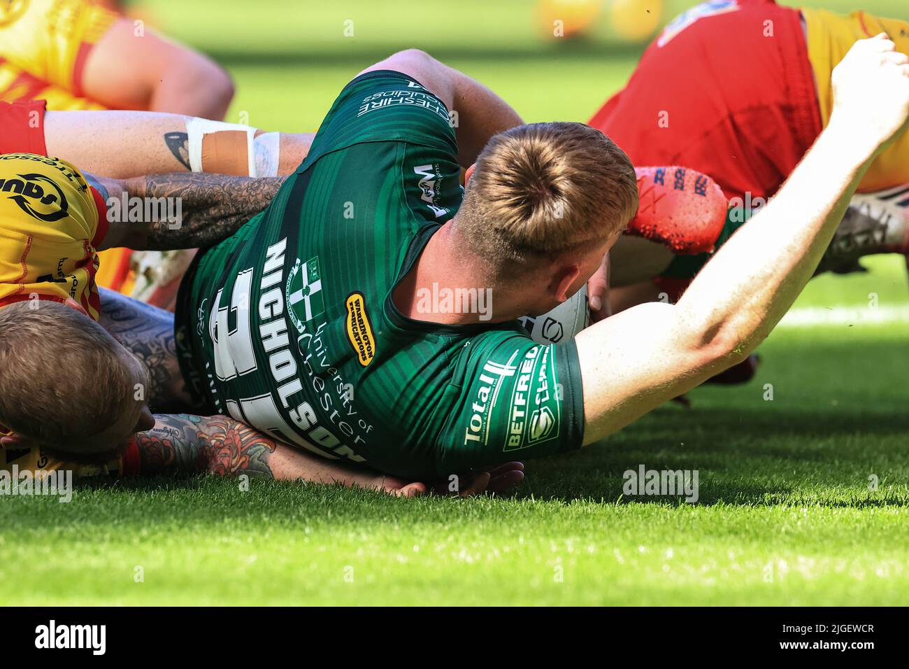 Matthew Nicholson #35 of Warrington Wolves goes over for a try on his ...
