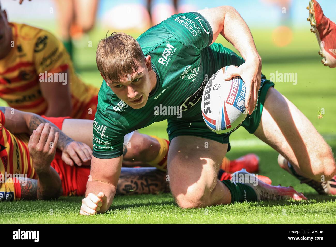 Matthew Nicholson #35 of Warrington Wolves goes over for a try on his ...