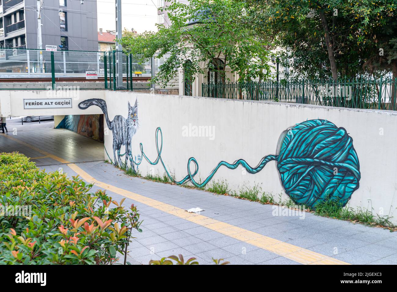 Mural depicting cats by Axel Mengu on walls under viaduct, bridge ...