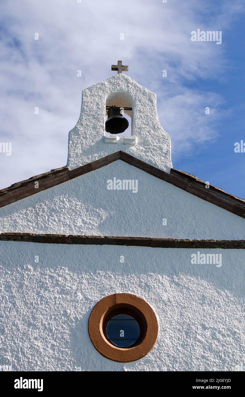 A vertical shot of a white wall and bell tower of a chapel Stock Photo ...