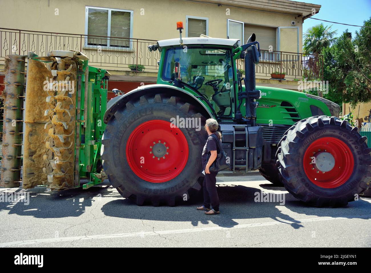 Cadoneghe, Veneto, Italy. The threshing feast. A big, modern tractor ...