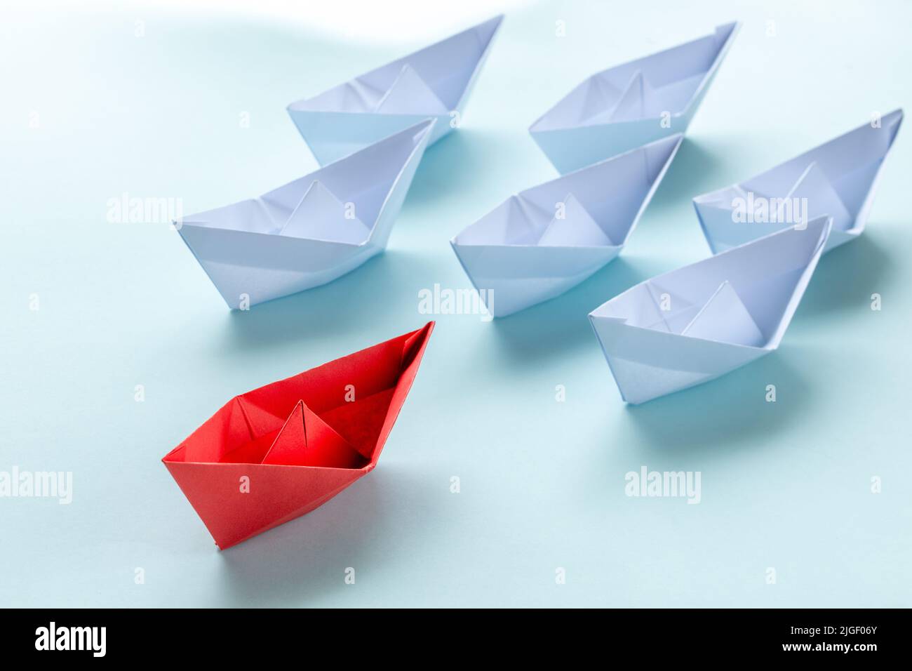 success leadership concept, red leader, white boats following the ...
