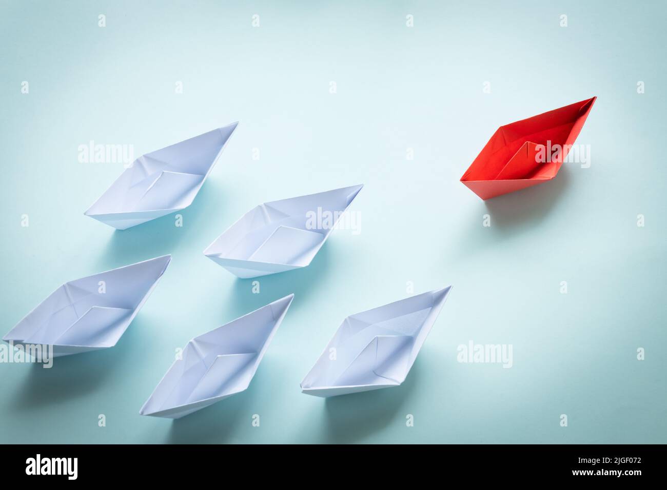success leadership concept, red leader, white boats following the ...