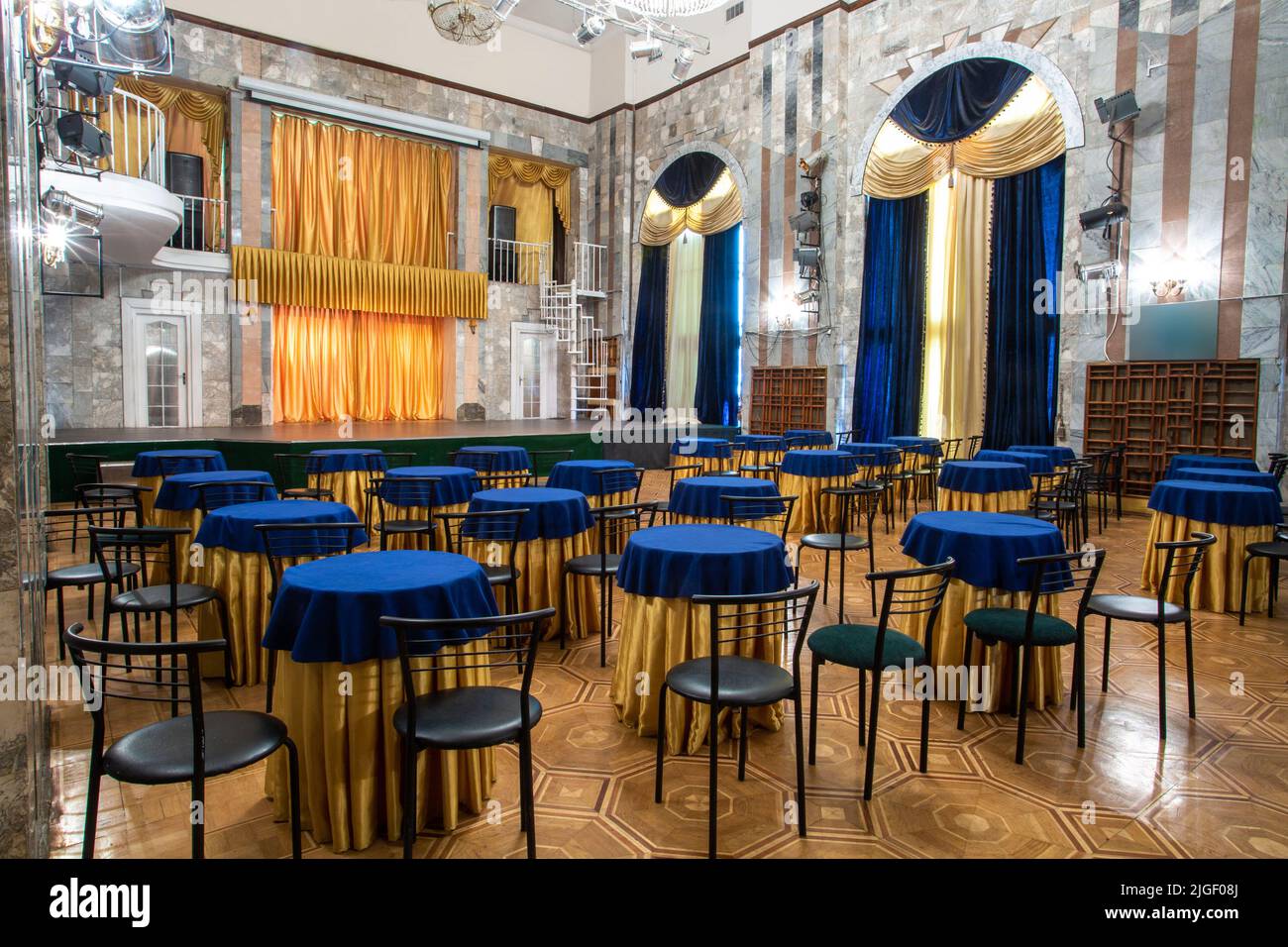 Image of a theater stage in front of tables in an empty café Stock ...