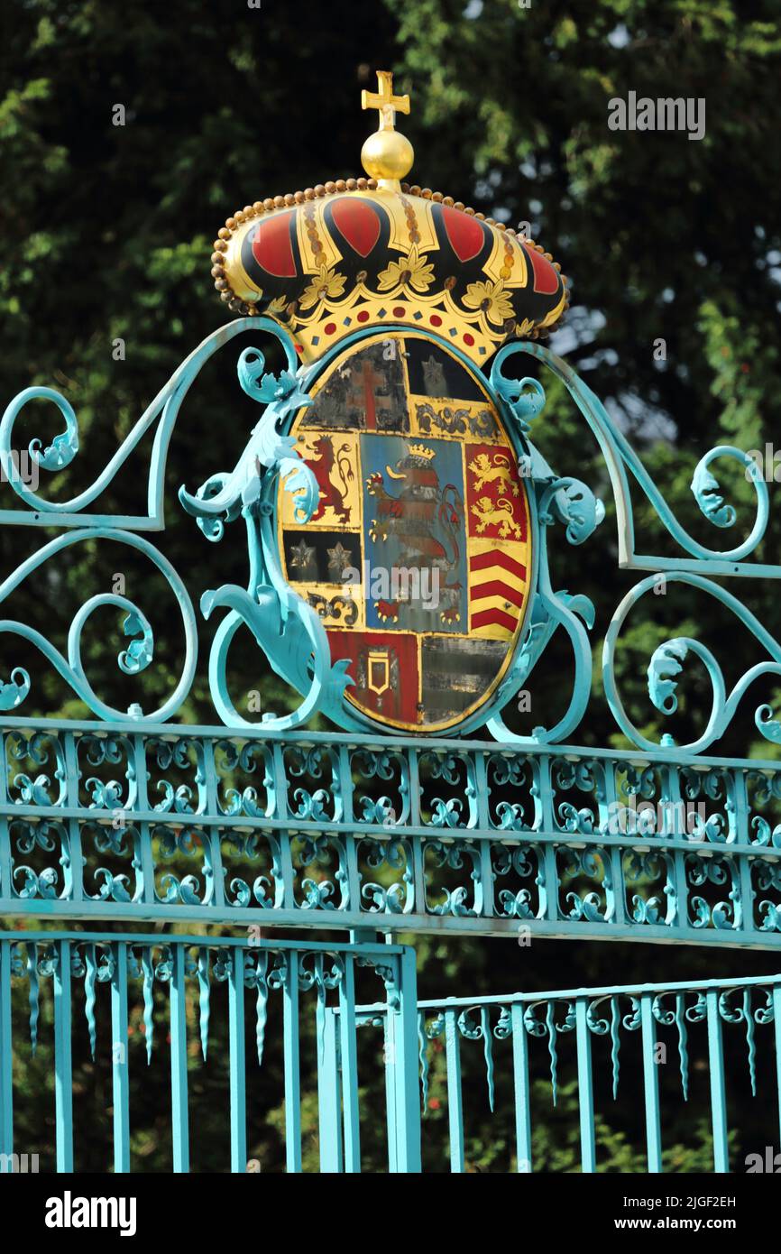 Decorated metal gate with a crown at the entrance to the palace gardens ...