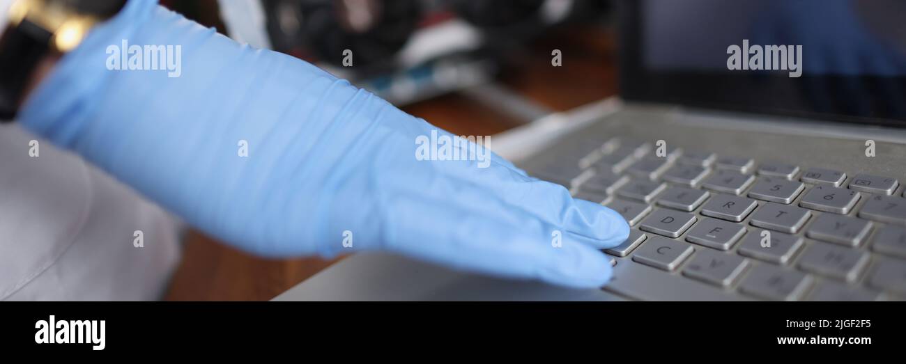 Professional technician man touching laptop keyboard wearing sterile ...
