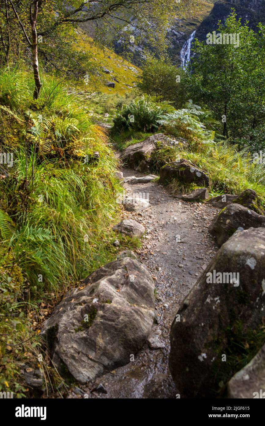 A hiking trail in the Nevis Gorge, with Steall Falls pictured in the ...