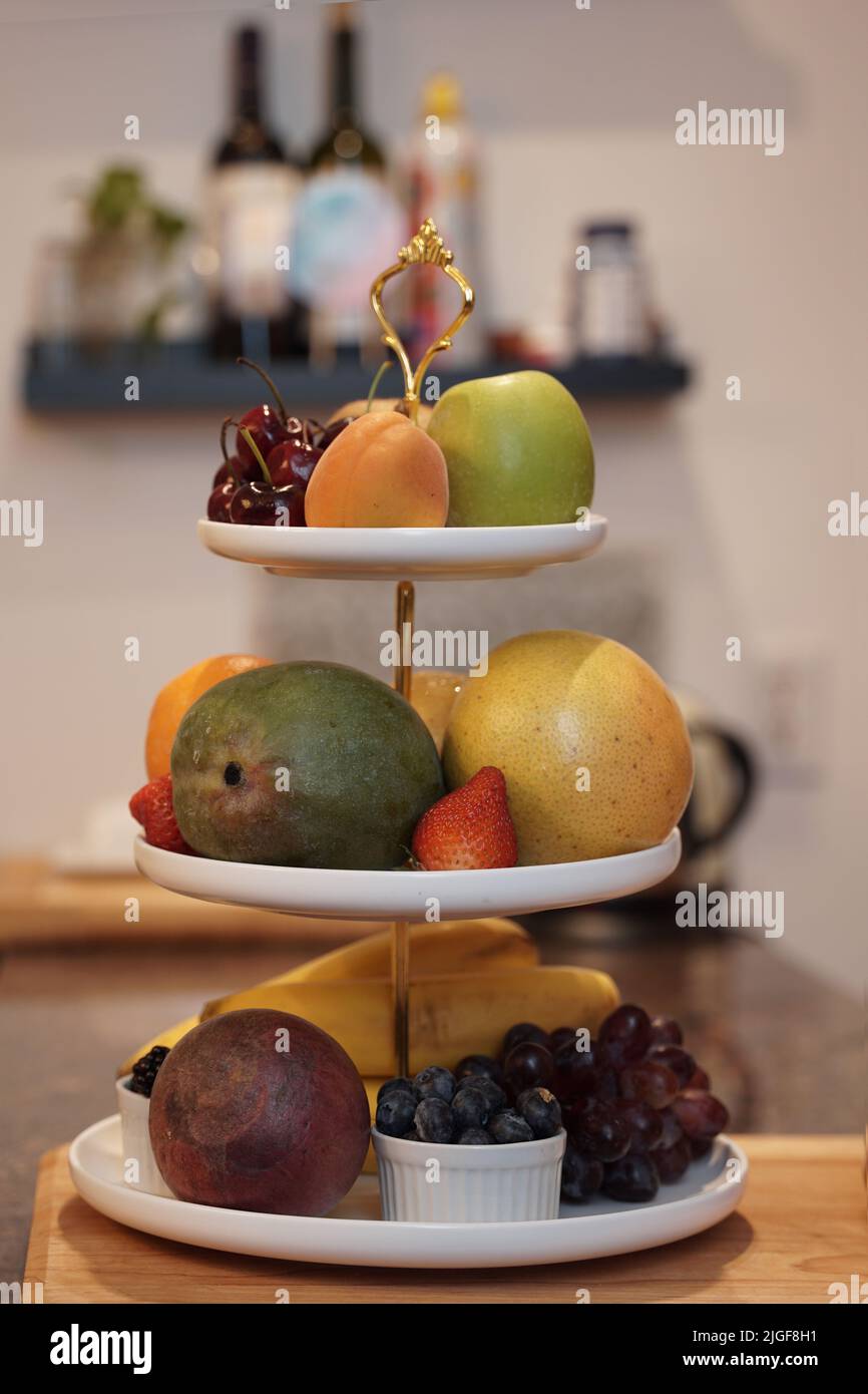 The fresh fruits on triple platter Stock Photo - Alamy