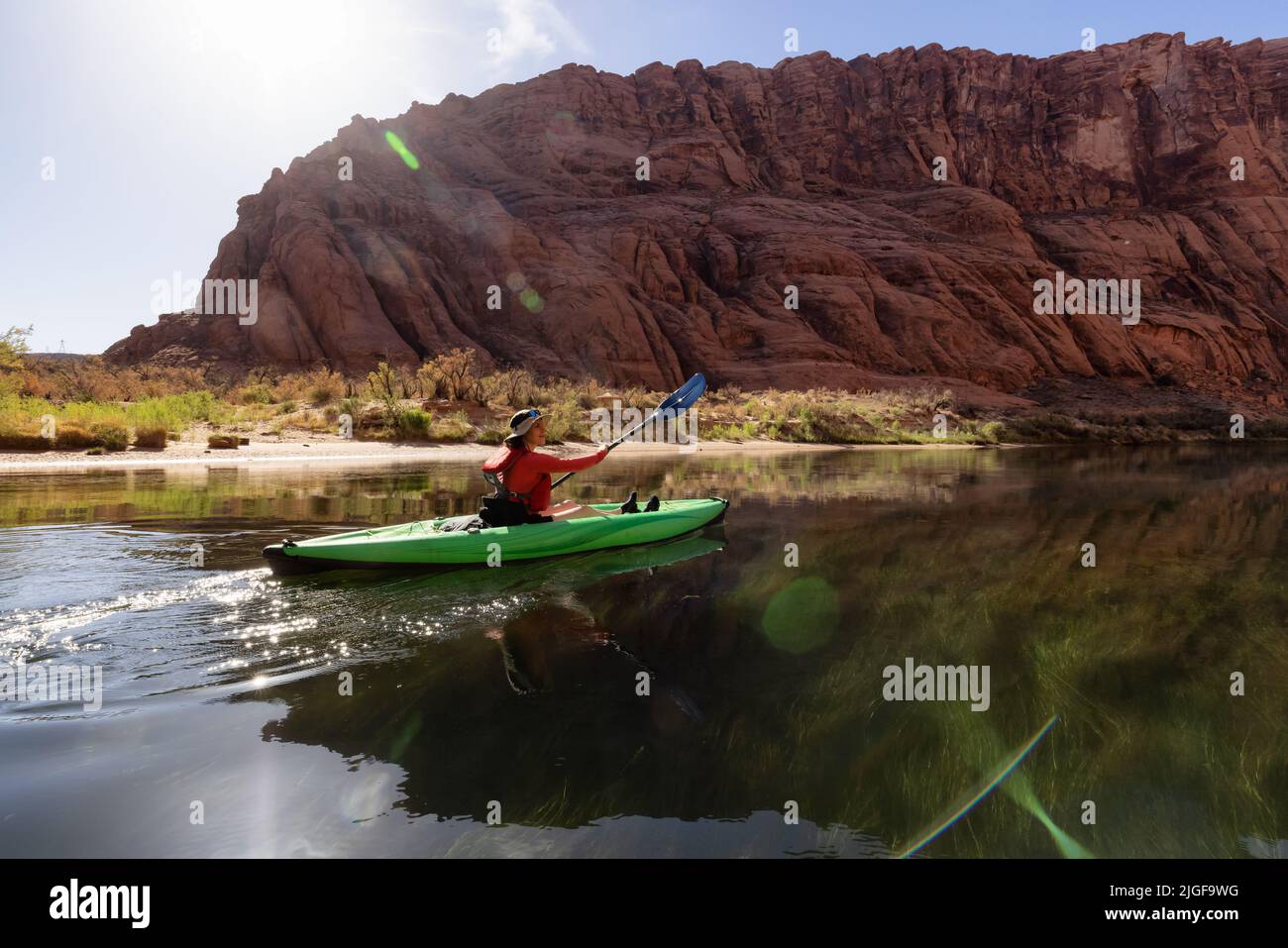 Adventurous Woman on a Kayak paddling in Colorado River. Glen Canyon ...
