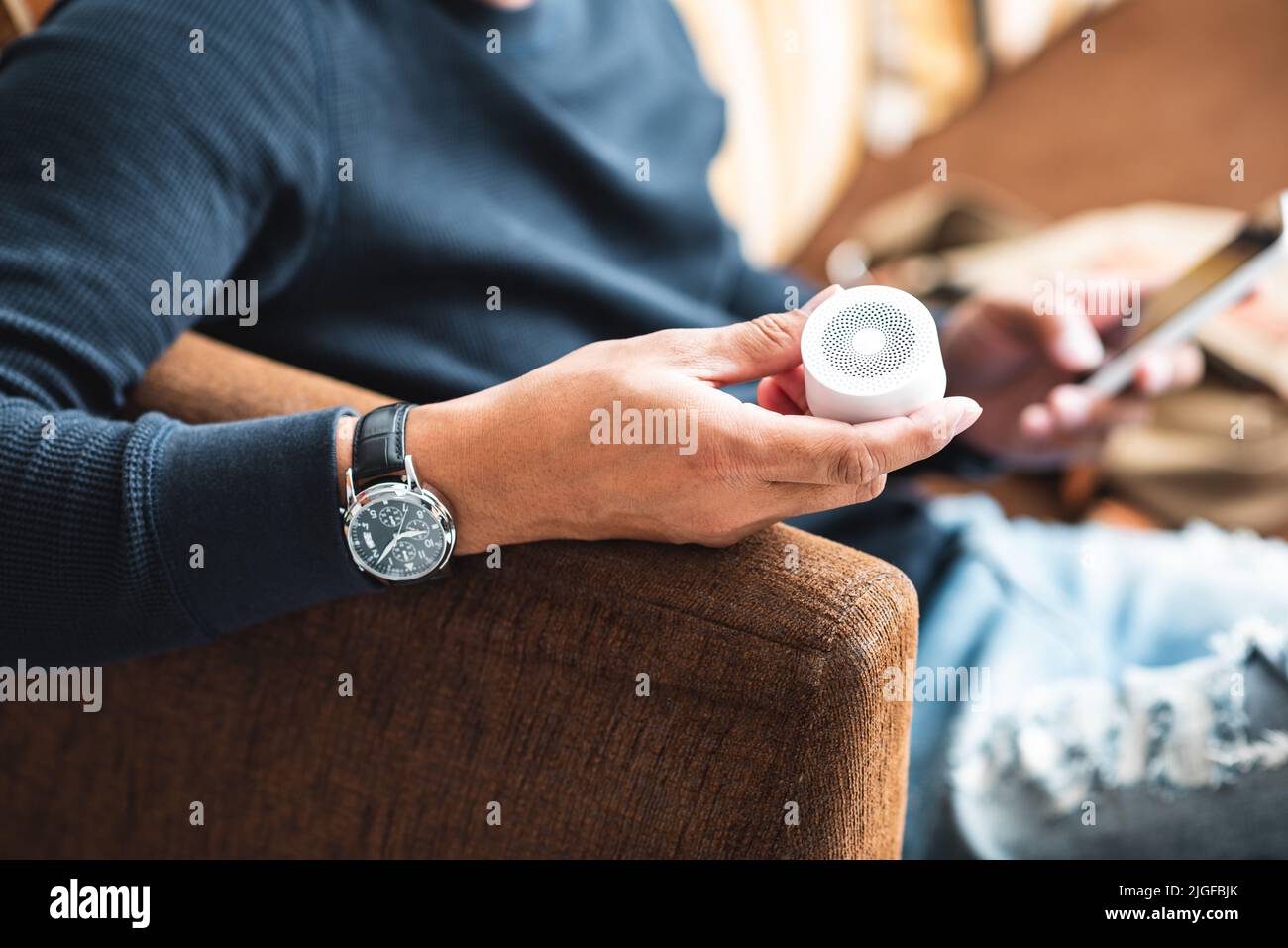 The man streams music from smartphone to bluetooth speaker Stock Photo ...