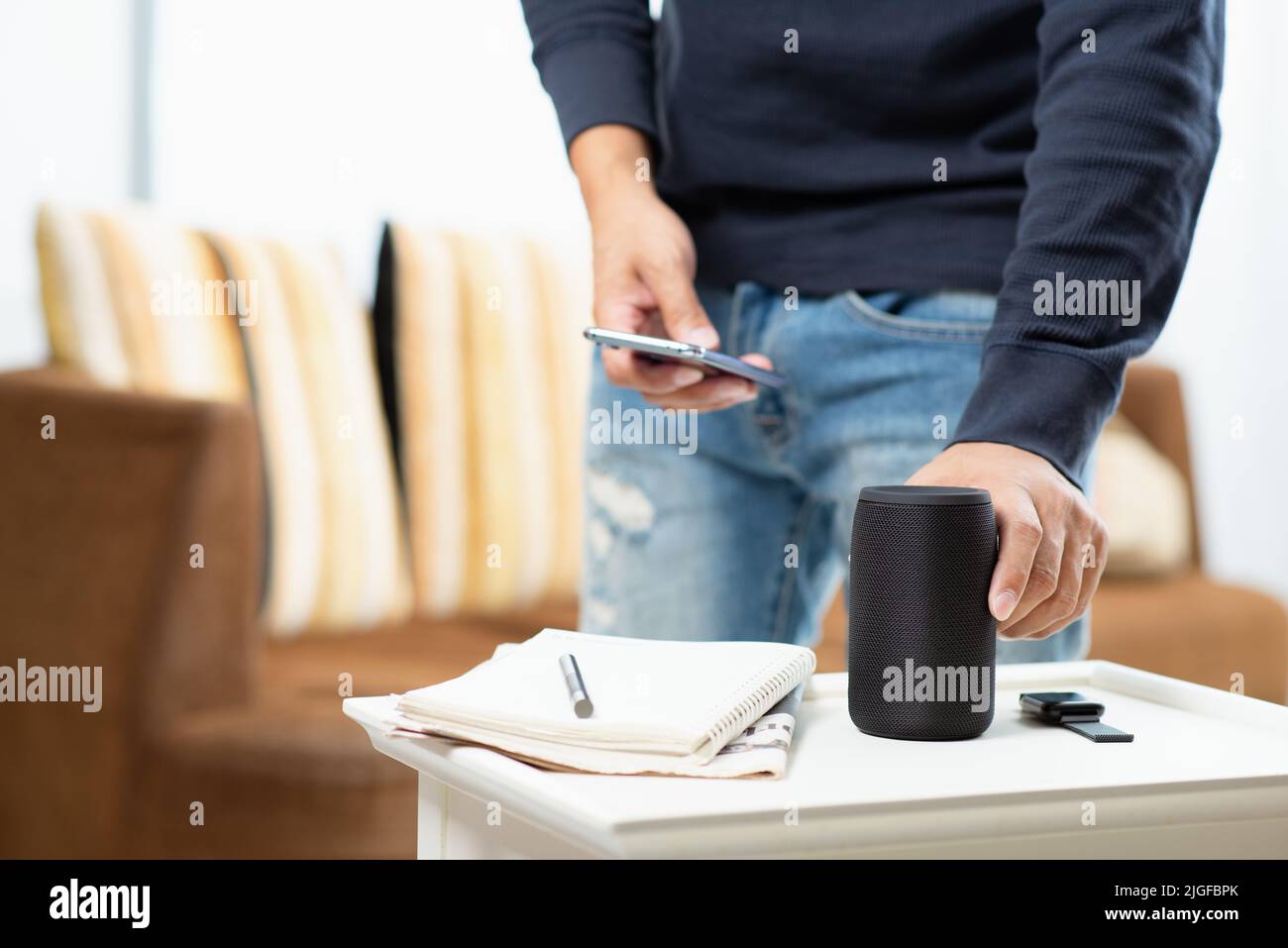 The man streams music from smartphone to bluetooth speaker Stock Photo ...