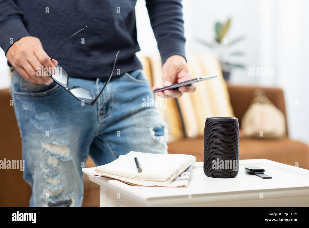 The man streams music from smartphone to bluetooth speaker Stock Photo ...