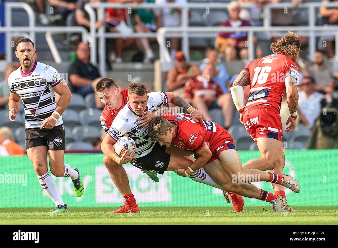 Jordan Lane #13 of Hull FC is tackled by Jimmy Keinhorst #18 of Hull KR ...