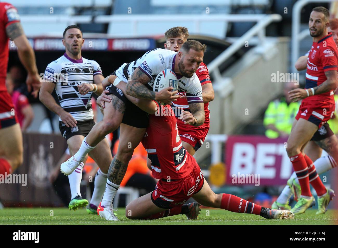 Josh Griffin #4 of Hull FC is tackled by Sam Wood #24 of Hull KR Stock ...