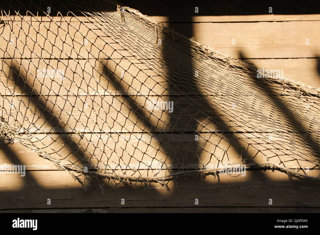 Fishing net at the fisherman's house. Fishnet hanging on the wooden ...