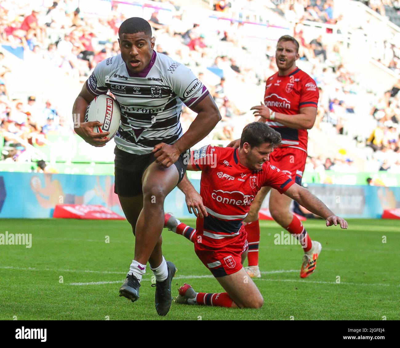 Joe Lovodua #14 of Hull FC gets past Lachlan Coote #1 of Hull KR to ...