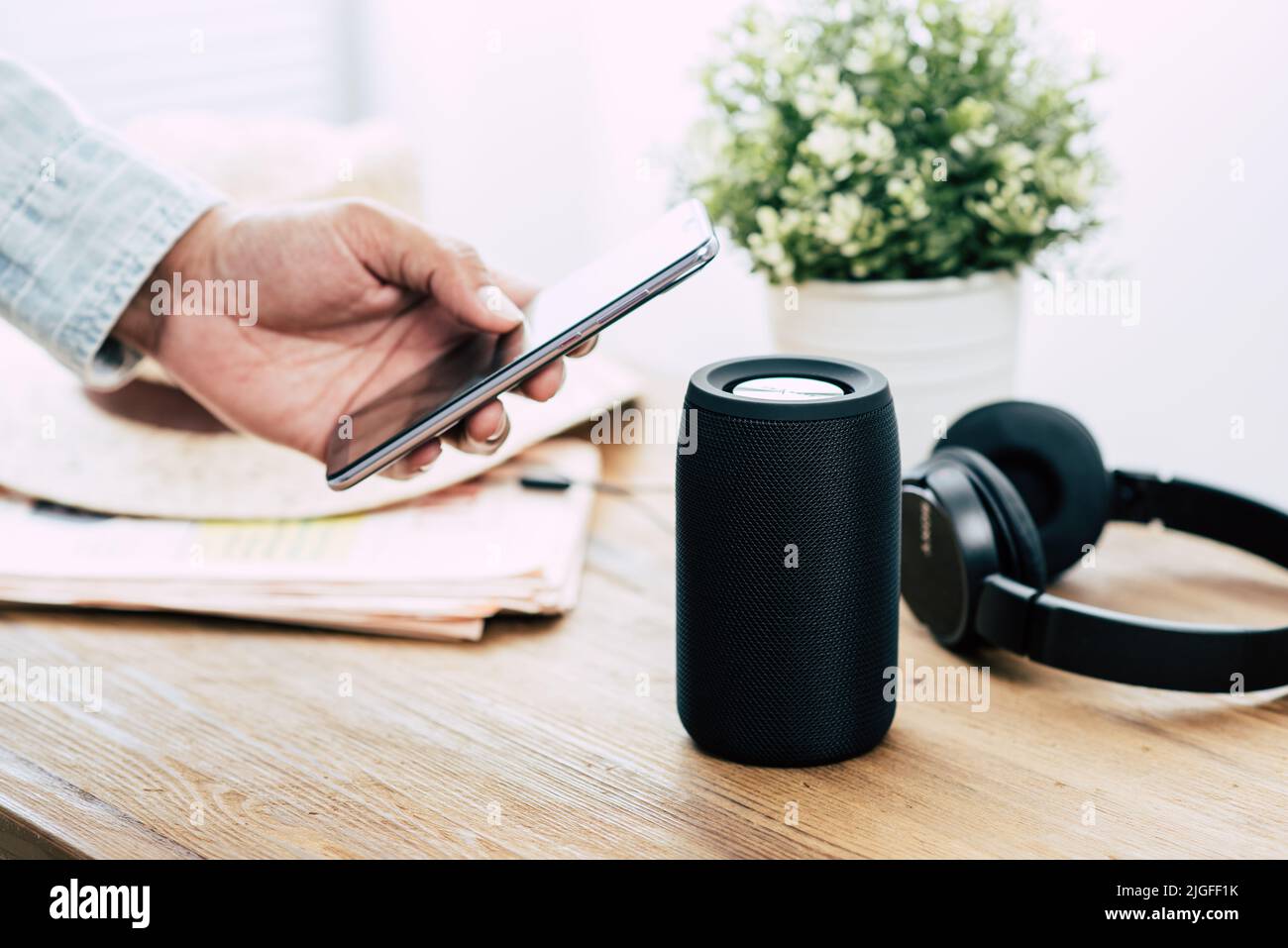The man streams music from smartphone to bluetooth speaker Stock Photo ...