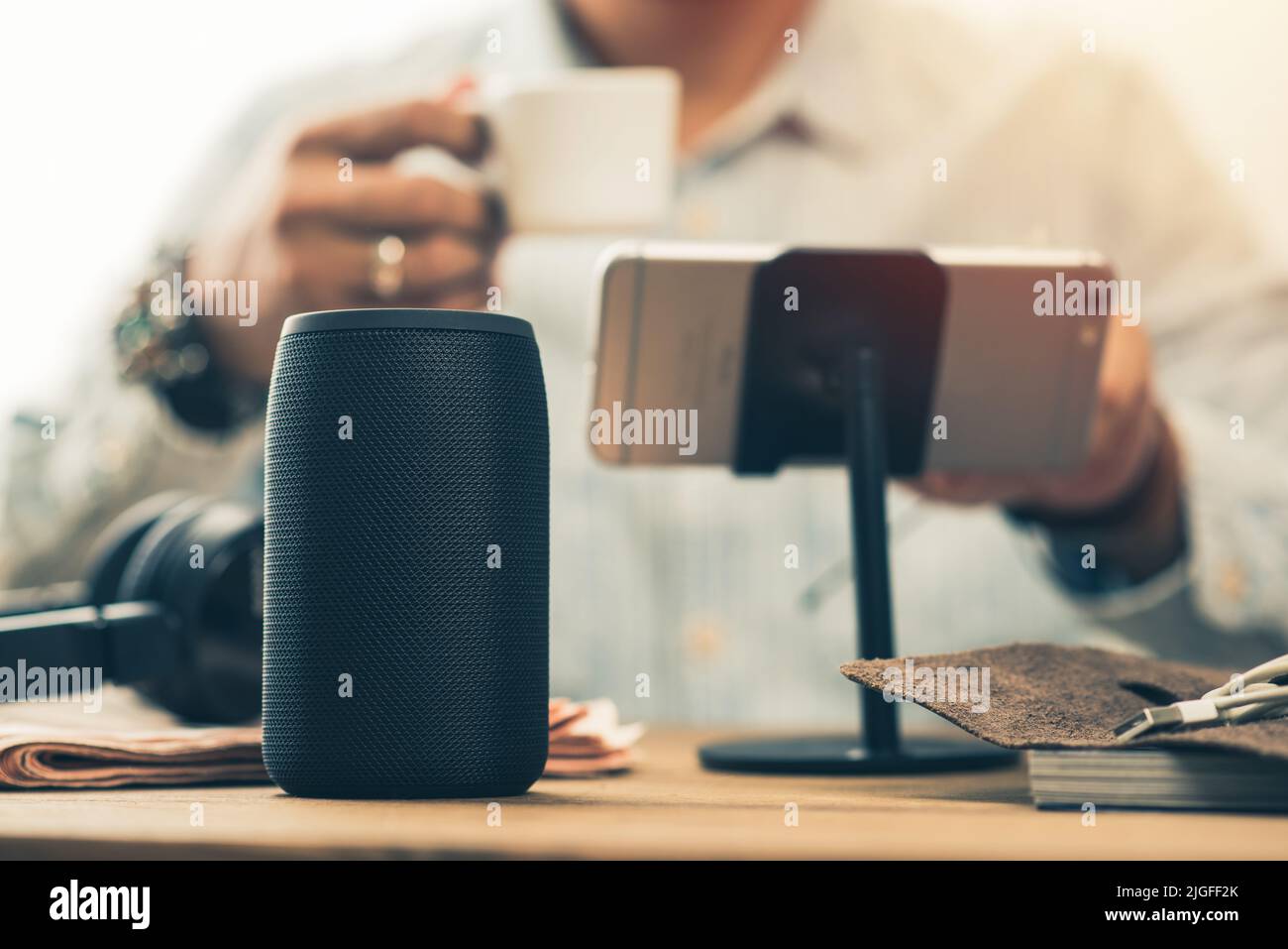 The man streams music from smartphone to bluetooth speaker Stock Photo ...
