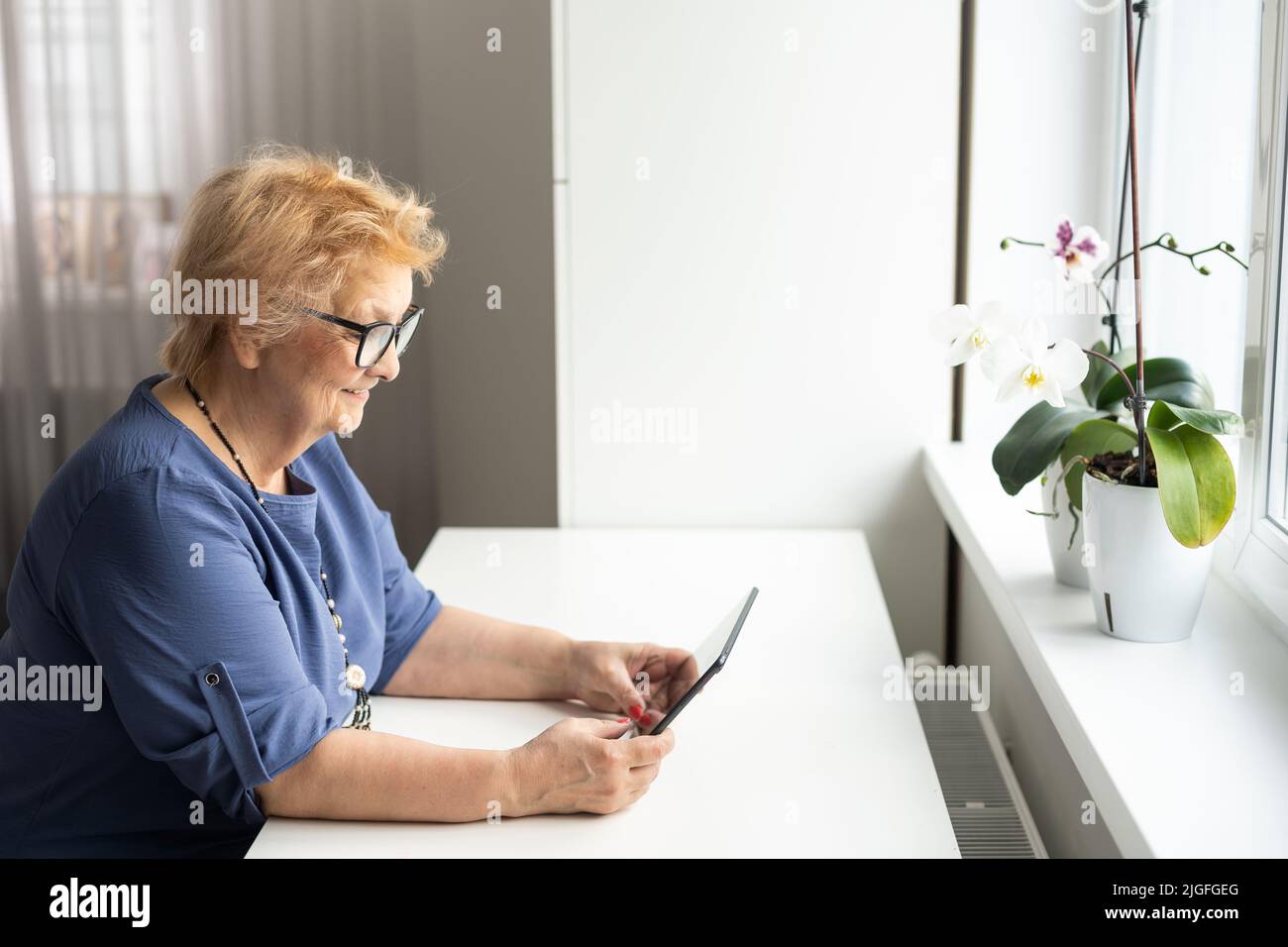 Authentic shot of a happy grandmother is making a video call to ...