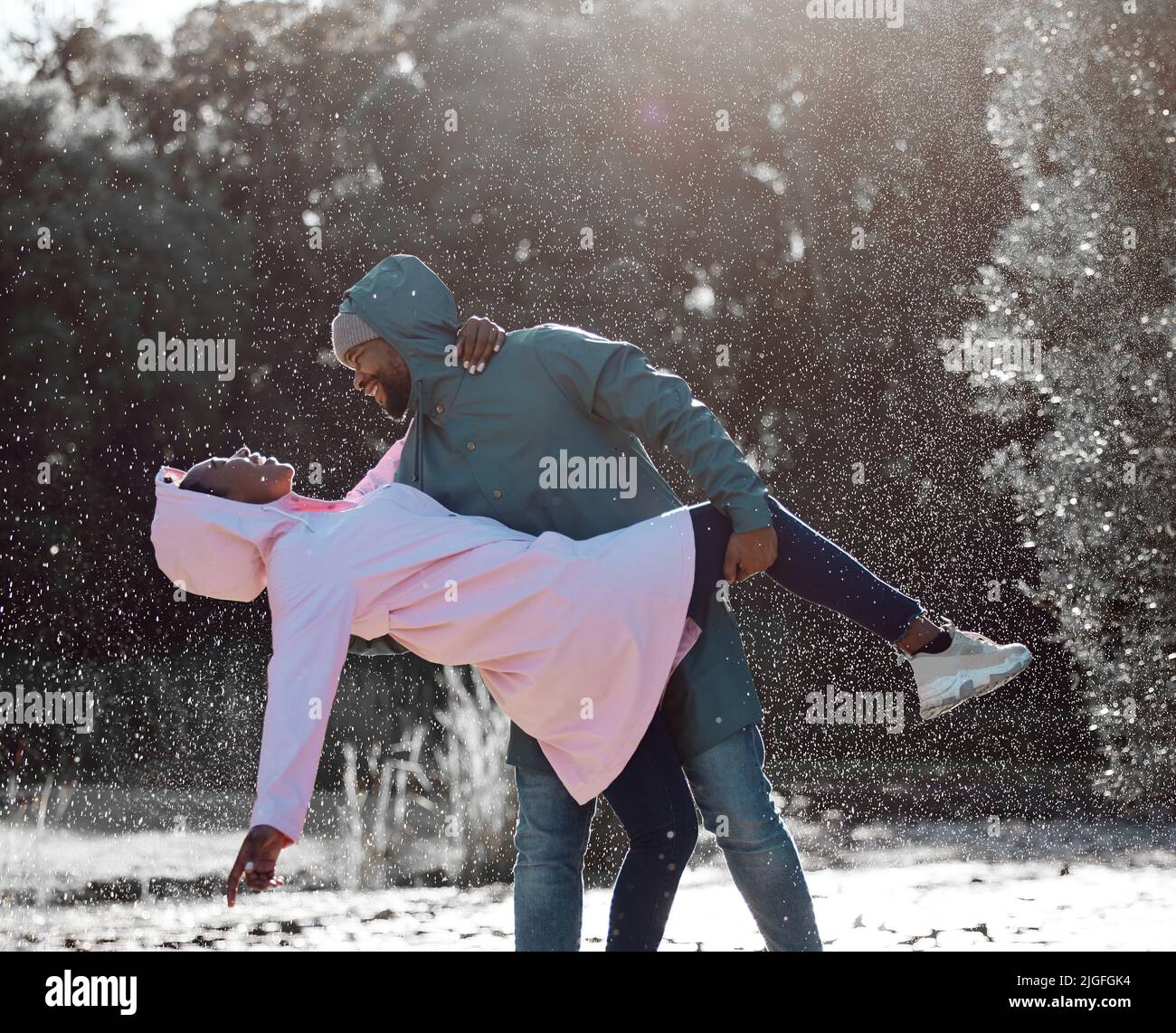 Our love story is my favourite one. a young couple dancing in the rain ...