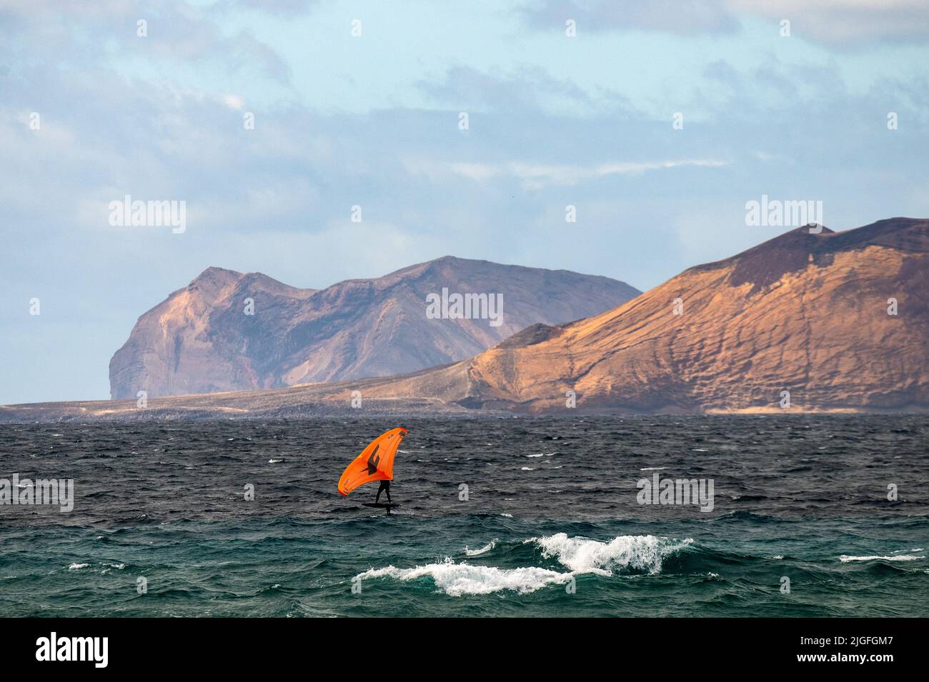A man practicing wing surf also known as wing foil in Famara Beach, in ...
