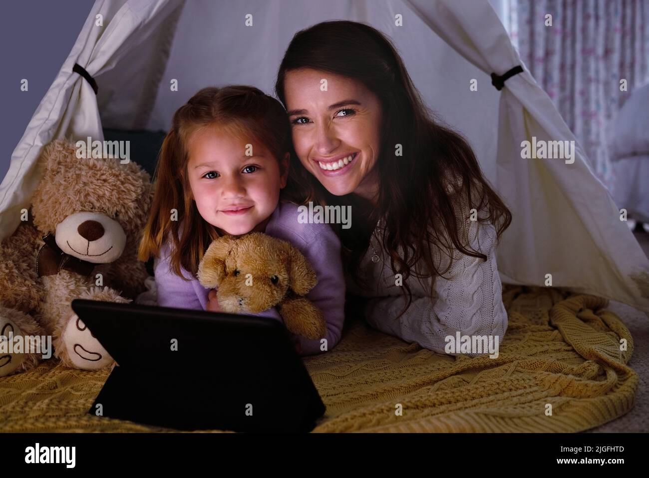 We indulge in some extra screen time on the weekend. a little girl and ...