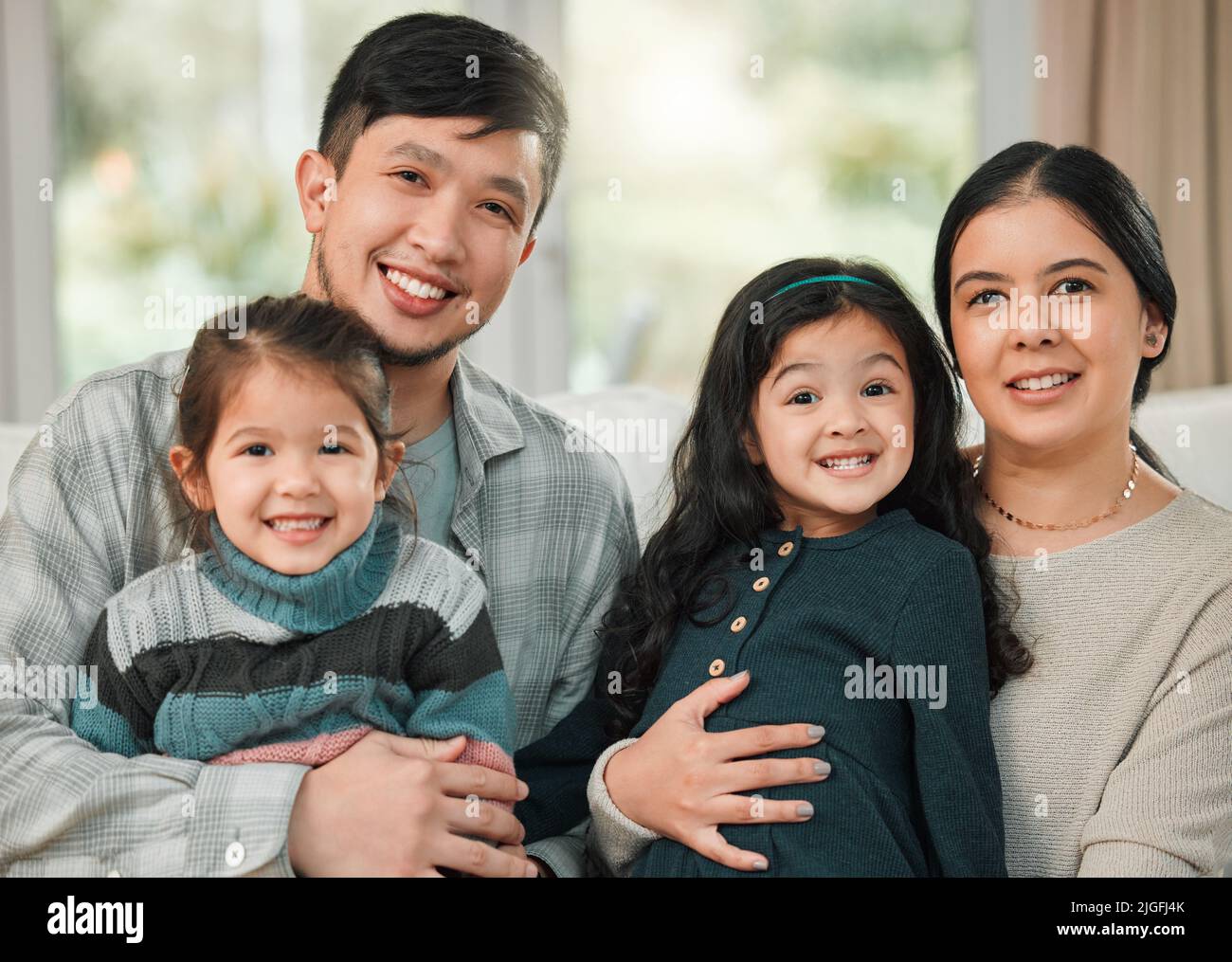 Perfect day for being lazy with the girls. Portrait of a young family ...