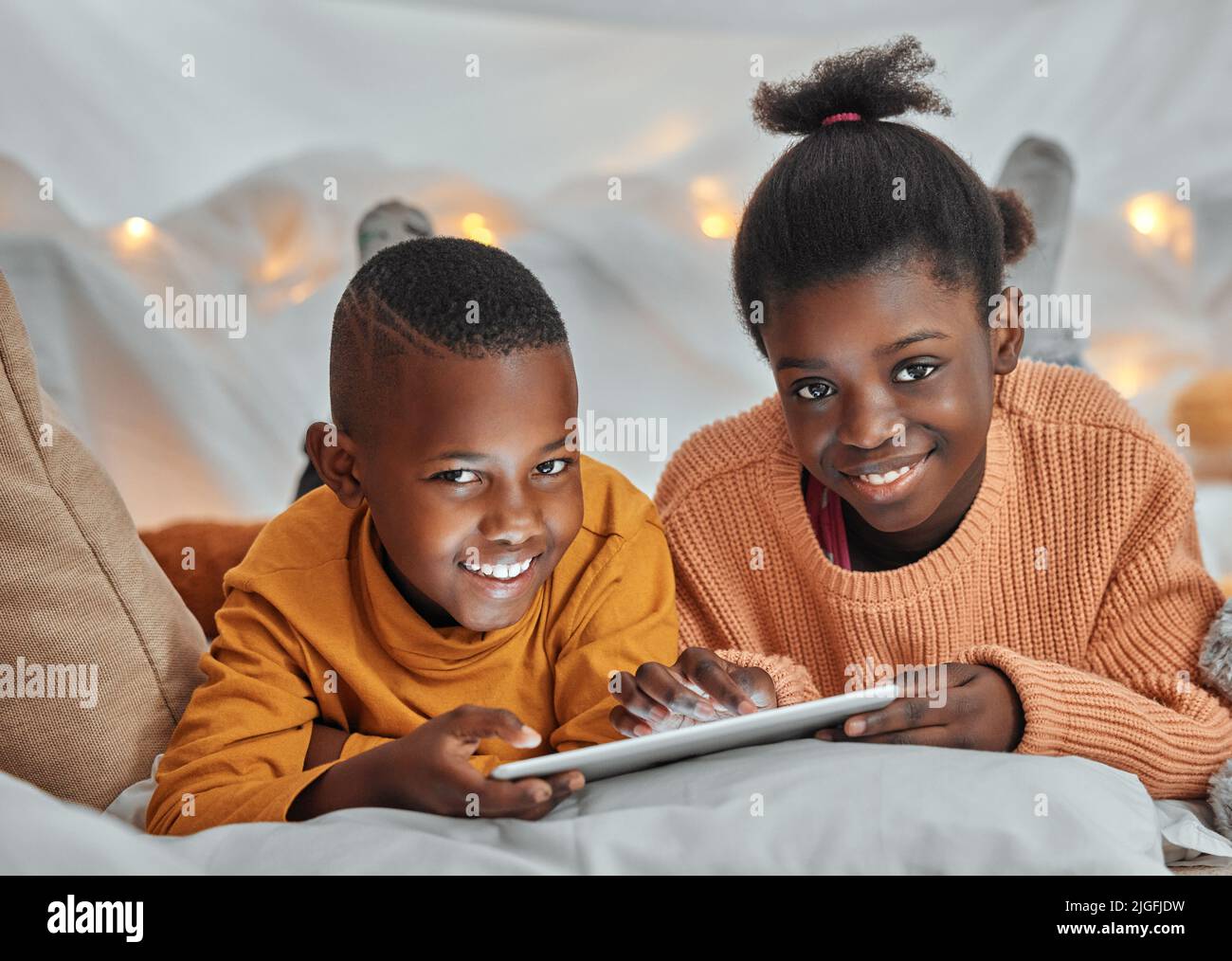 Cartoons before bedtime is a must. Portrait of a brother and sister ...