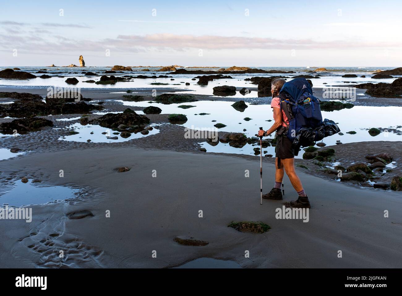 WA20569-00....WASHINGTON - Backpacker on the beach north of Cape ...