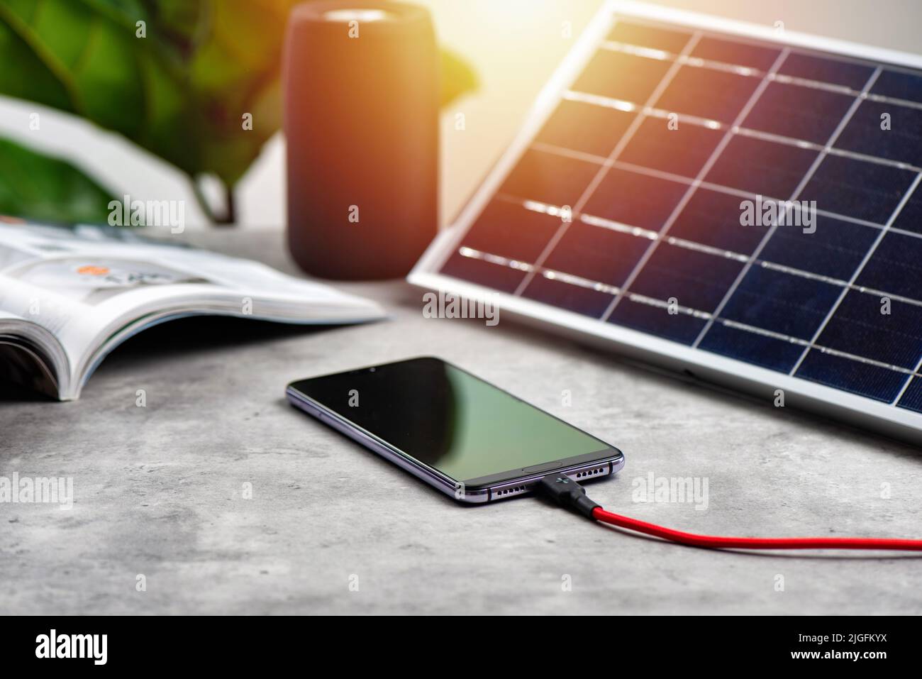 Charging the smartphone with solar energy. Green energy concept Stock ...