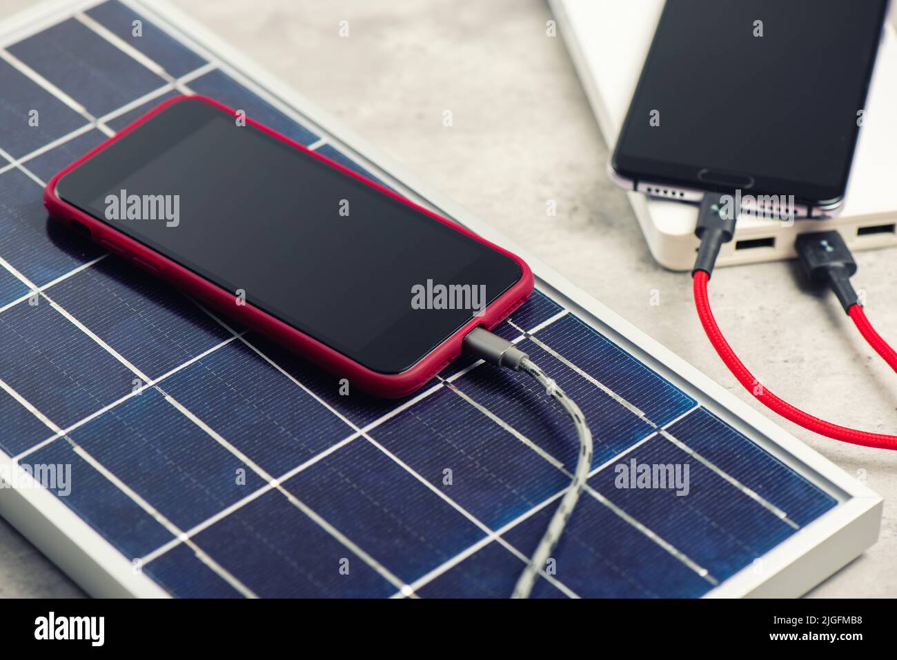 Charging the smartphone with solar energy. Green energy concept Stock ...