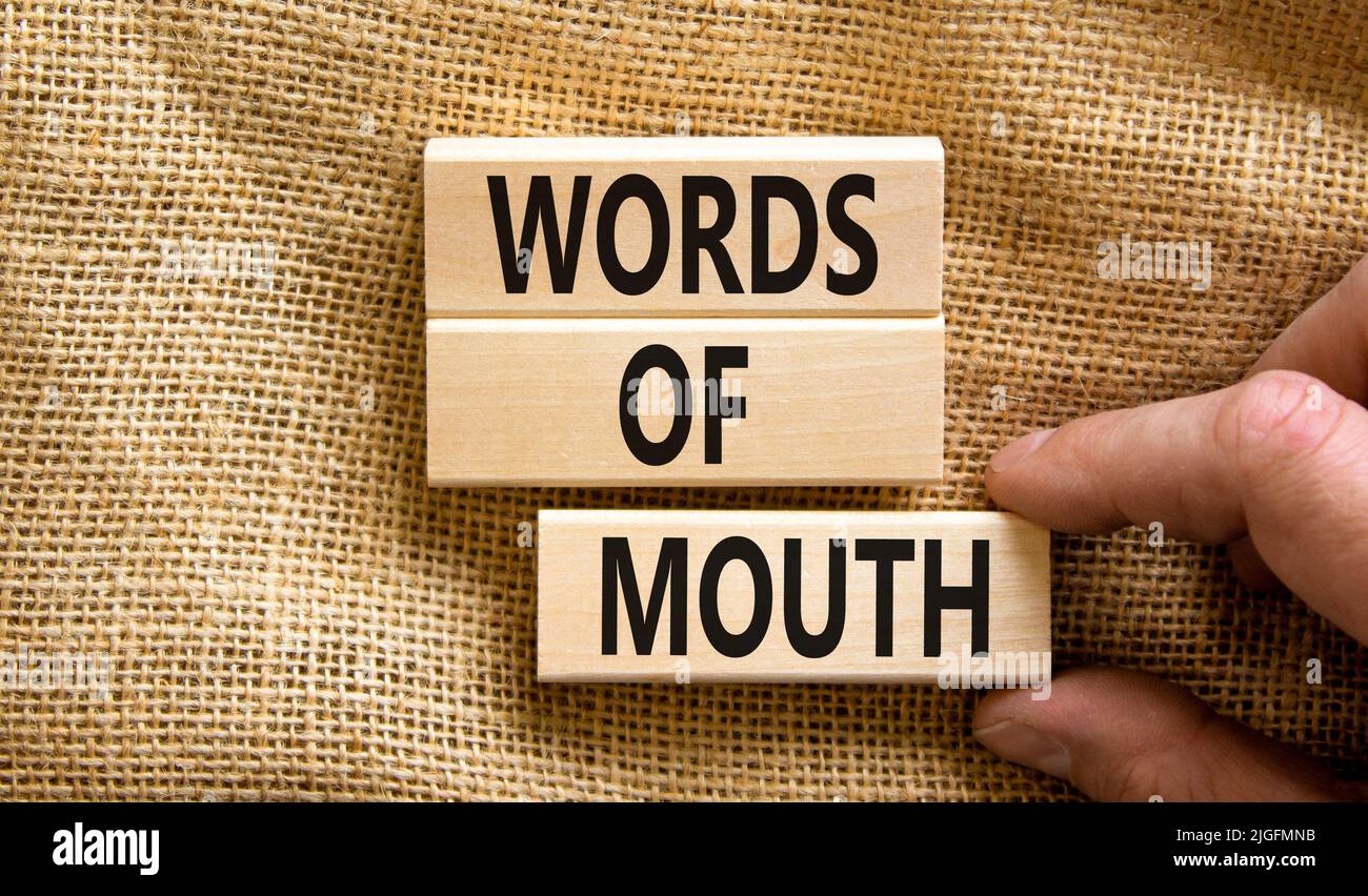 Words of mouth symbol. Concept words Words of mouth on wooden blocks on ...