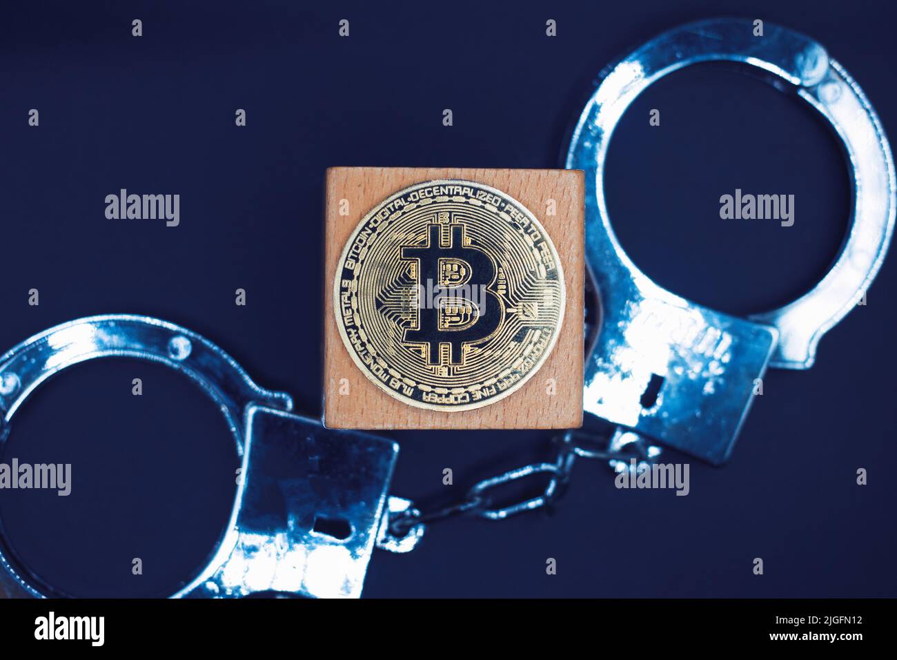 The bitcoin in the center with handcuffs as background . Concept of ...