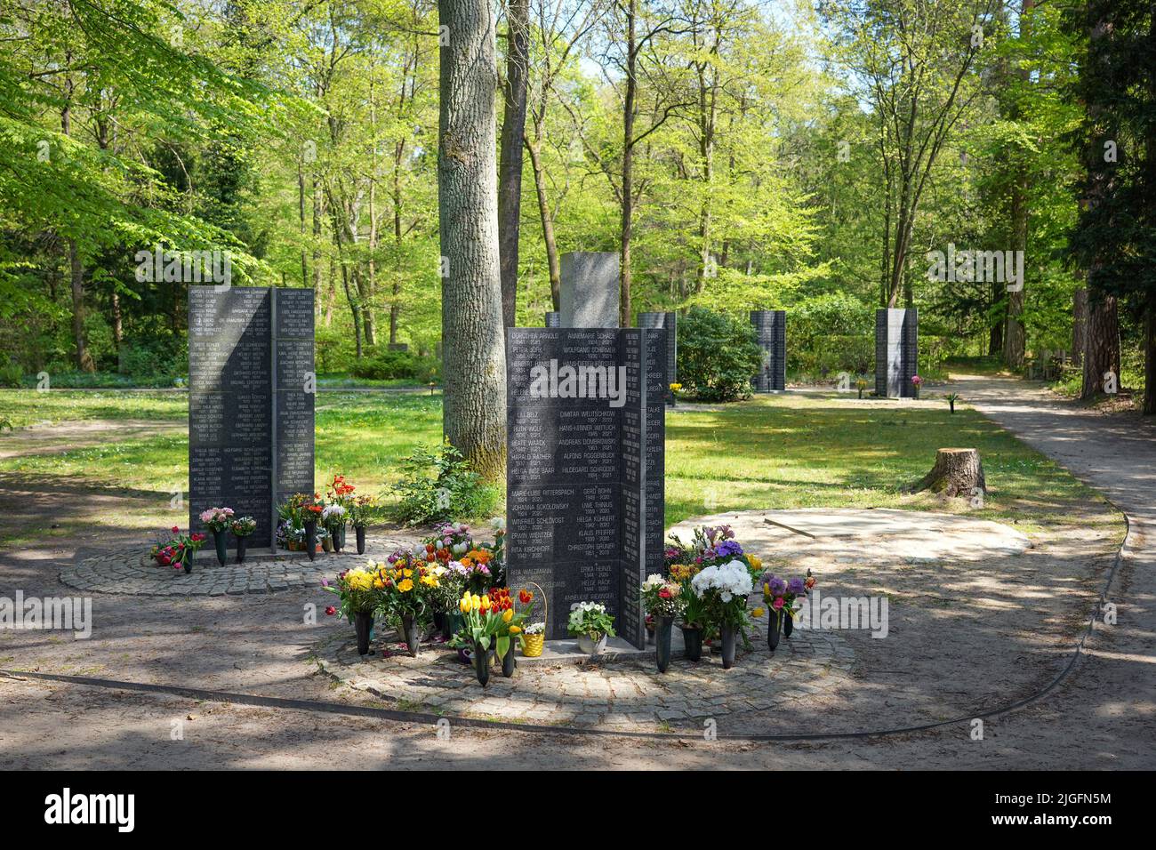 02 May 2022, Brandenburg, Stahnsdorf: Stone stelae with the engraved ...