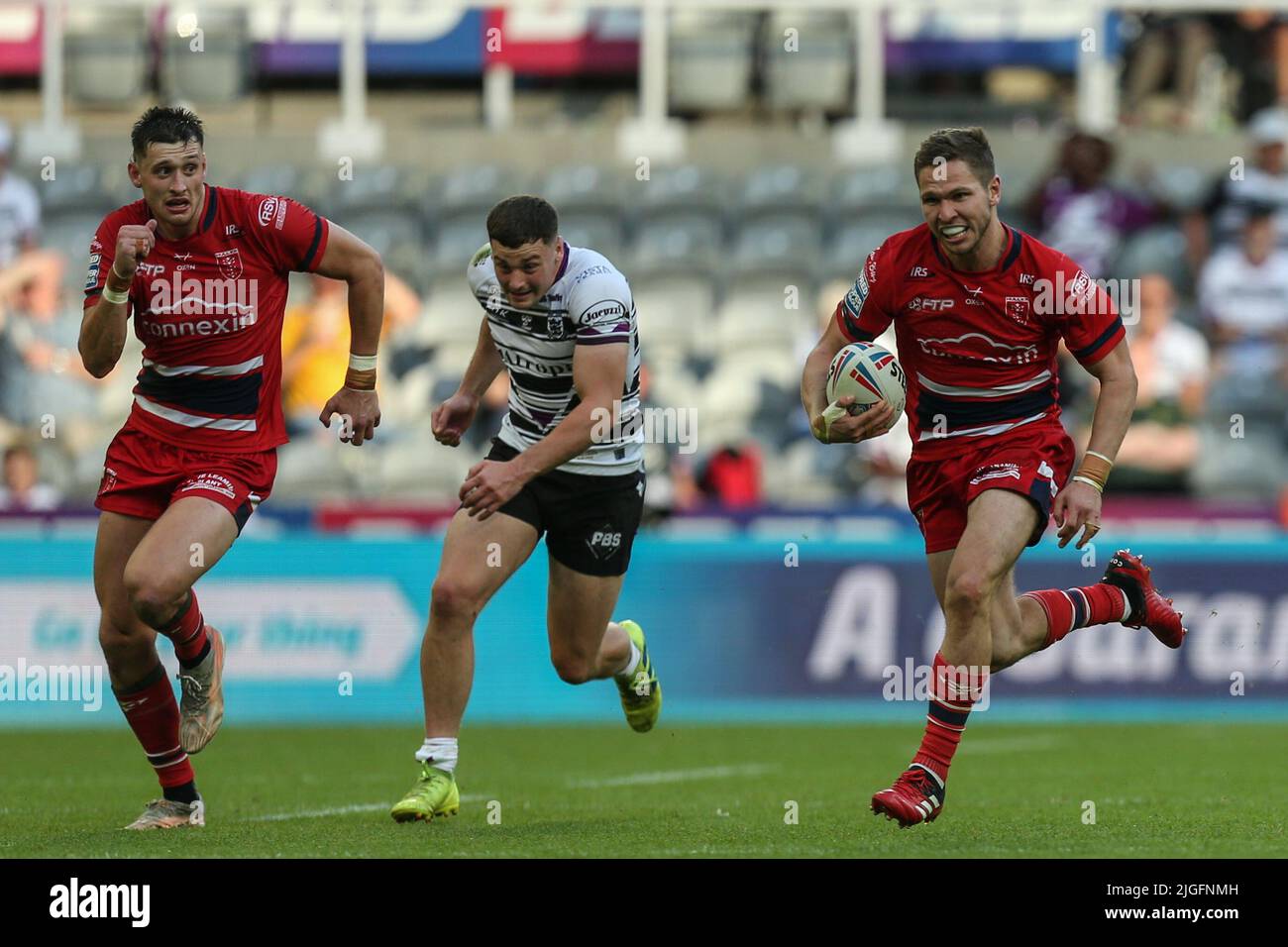 Matt Parcell #9 of Hull KR gets past the Hull FC defence to make a run ...
