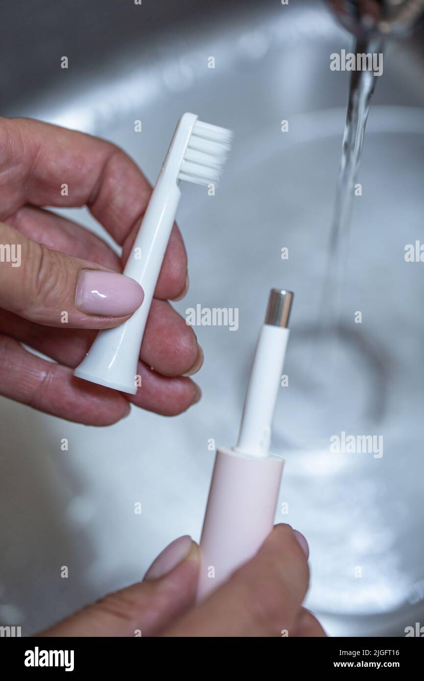 women's hands close up washing a toothbrush Stock Photo - Alamy