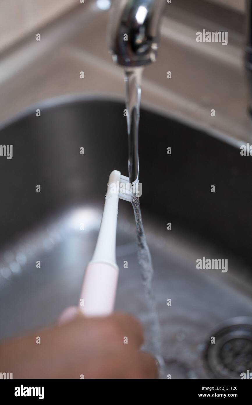 women's hands close up washing a toothbrush Stock Photo - Alamy