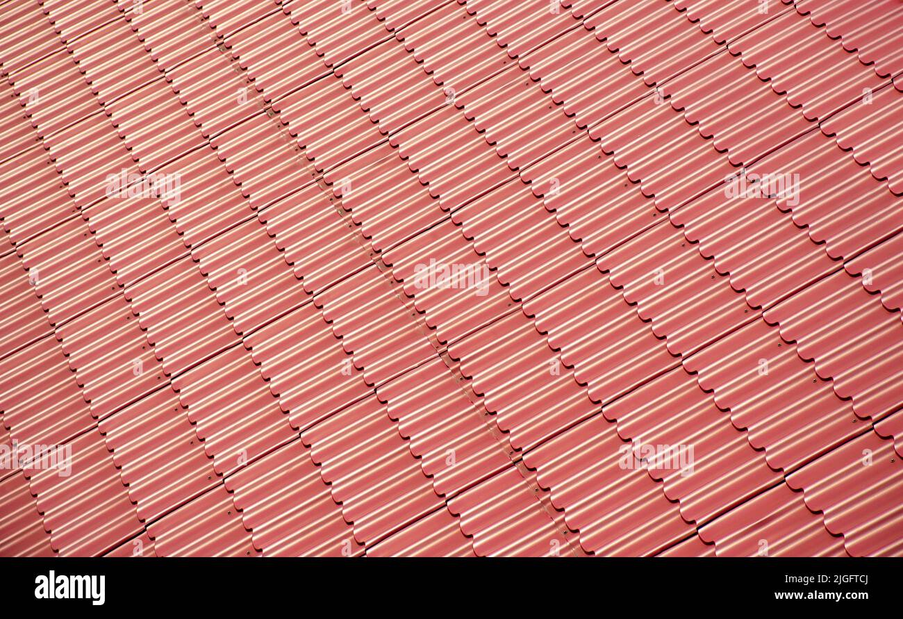Modern roof made of corrugated red metal tiles roofing Stock Photo - Alamy
