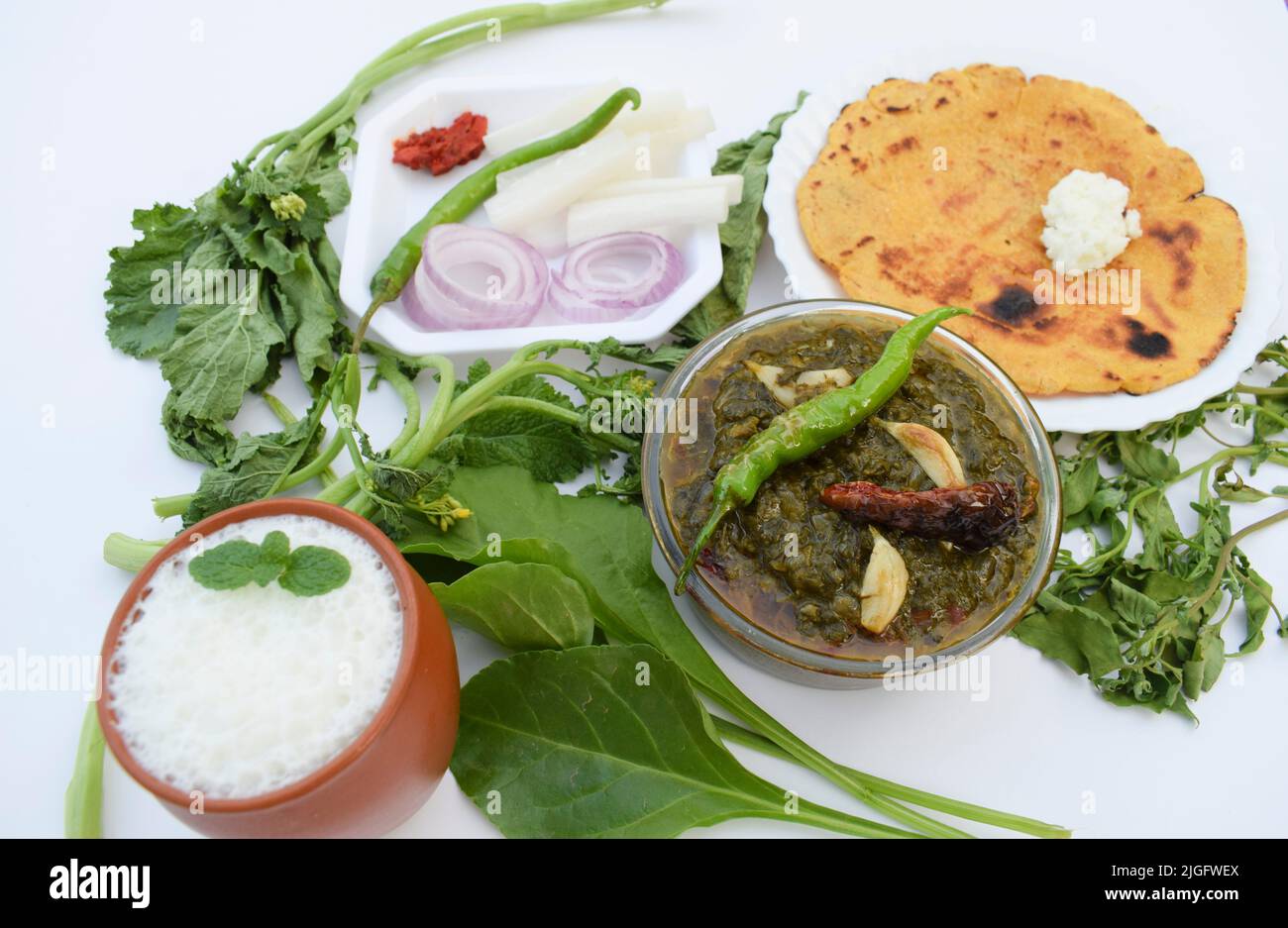 IndiaMakki roti and sarson saag with onion chilly salad and earthened ...